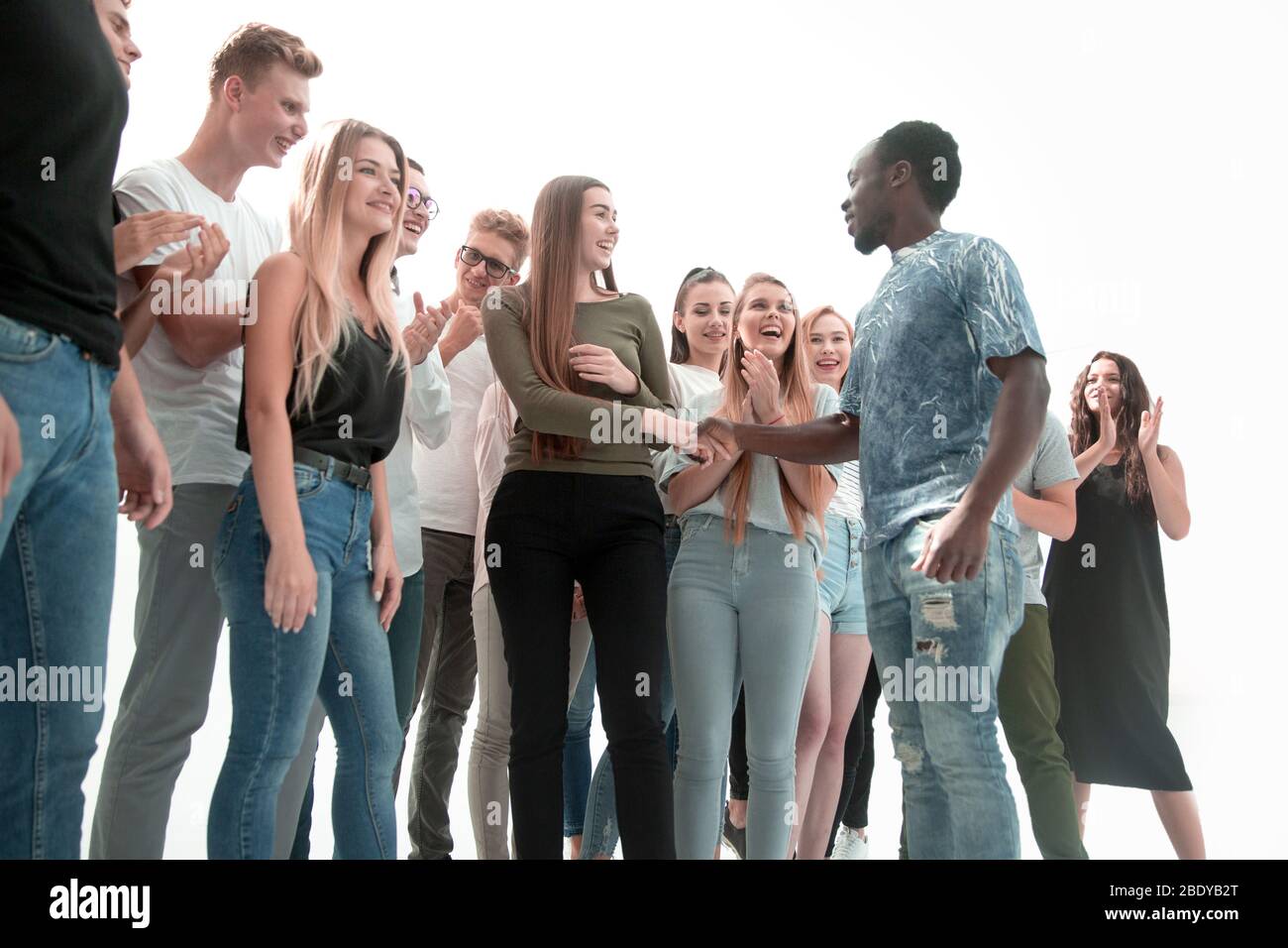 young people greeting each other with a handshake Stock Photo - Alamy