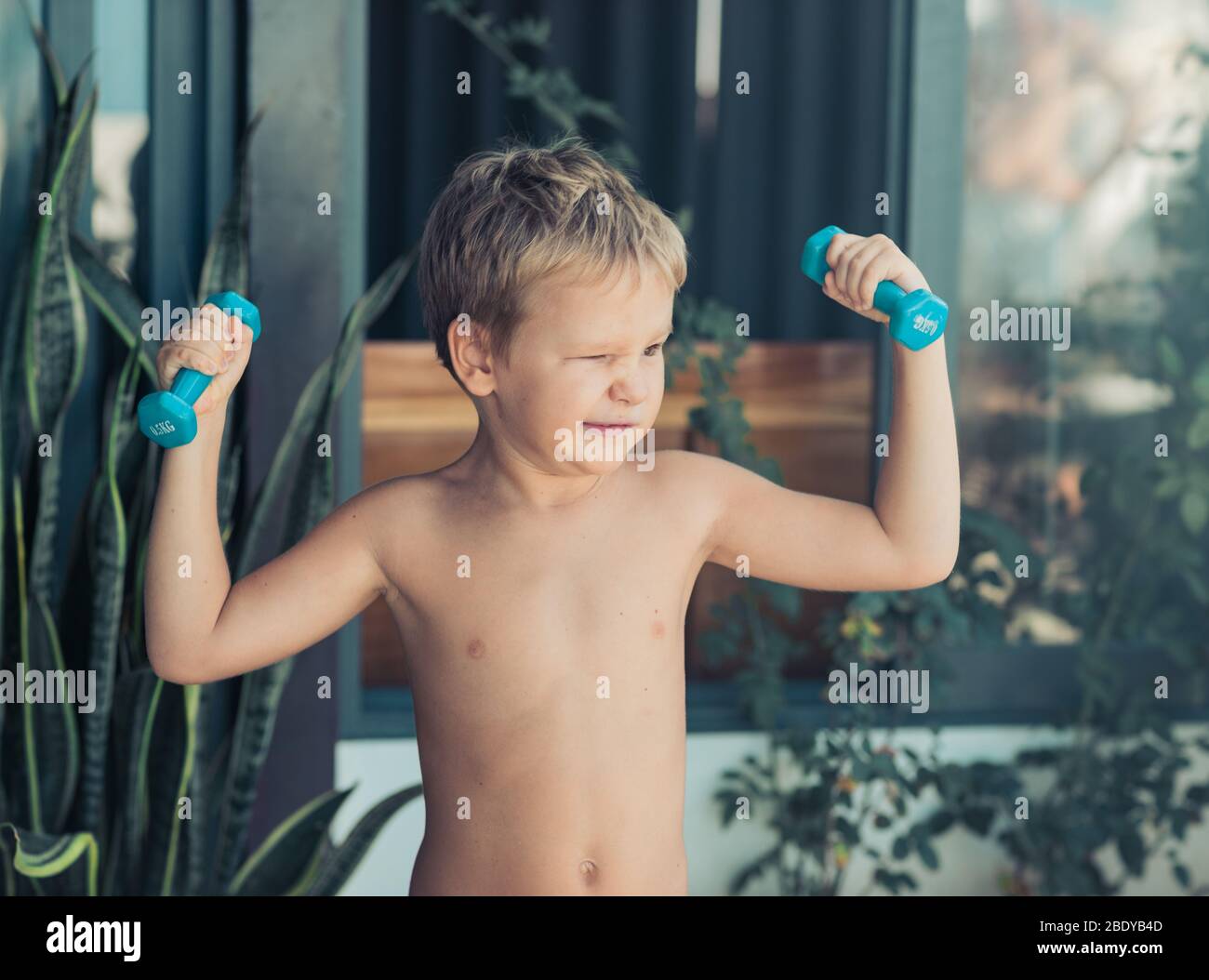 Portrait of a boy doing exercises. Self isolation at home Stock Photo ...