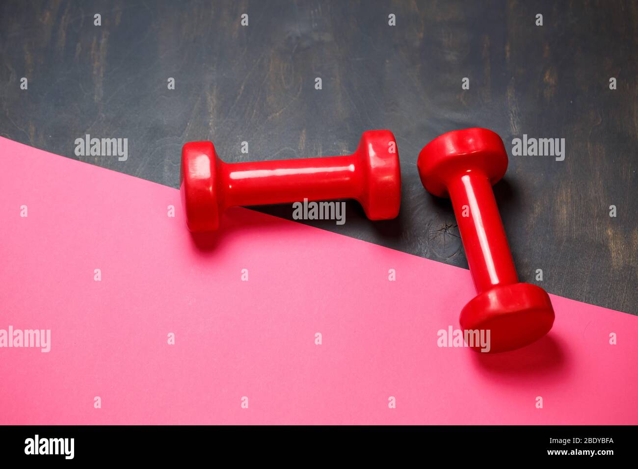 Conceptual fitness and healthy sport background with pink dumbbell on ...