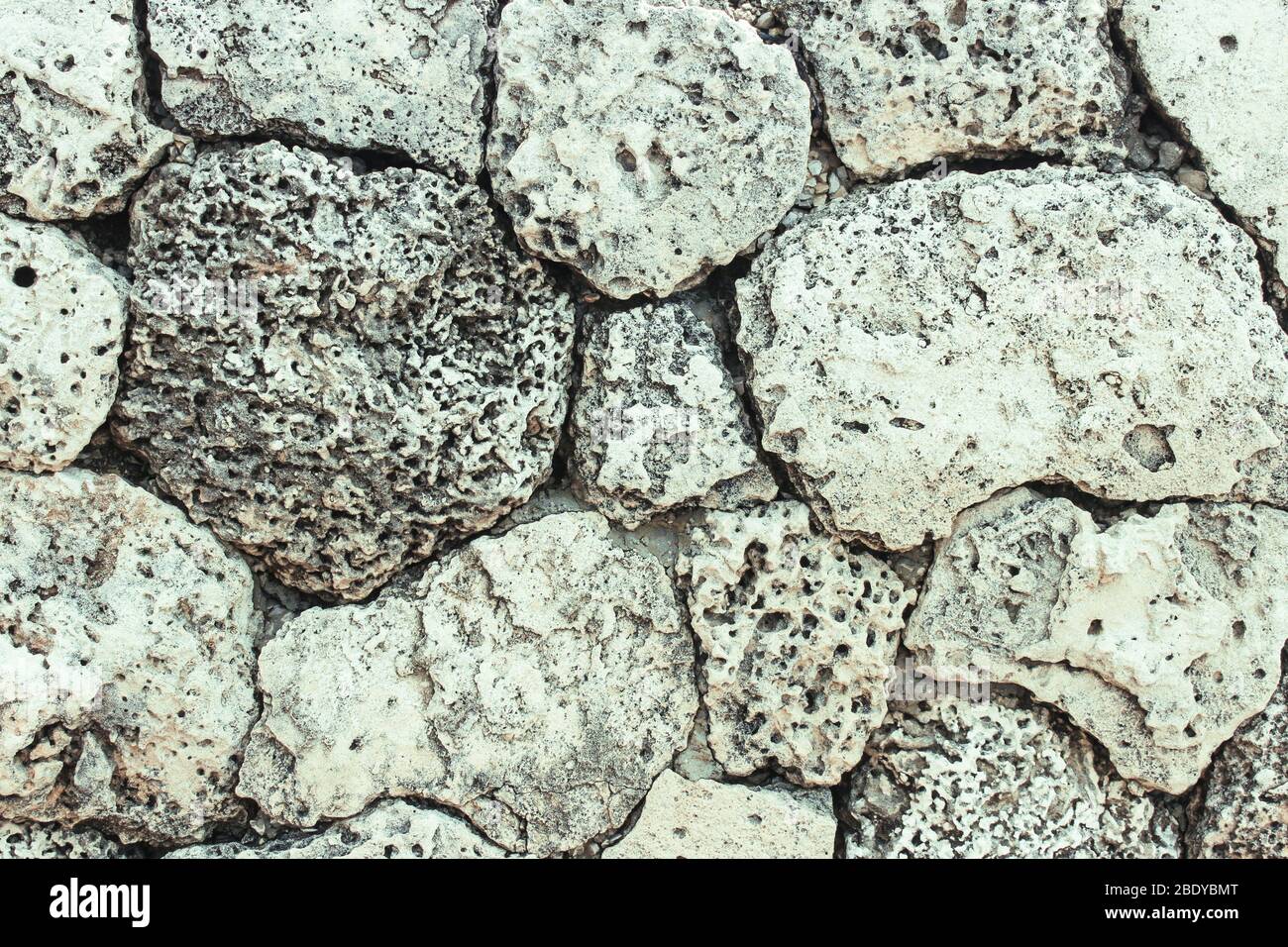 Texture of stone masonry of various shapes close up as a background ...