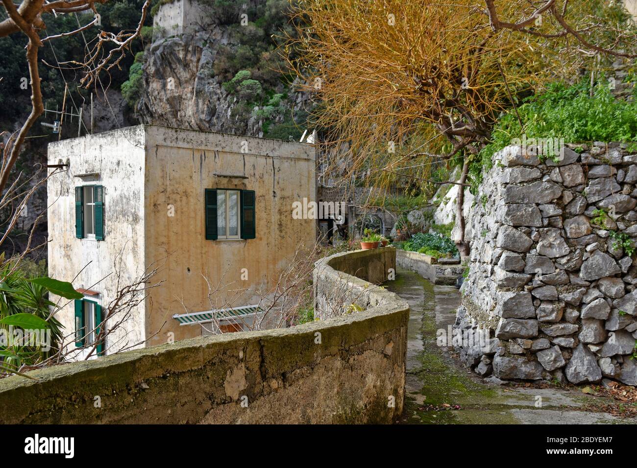 A narrow street between the houses of Scala, a town in the province of ...