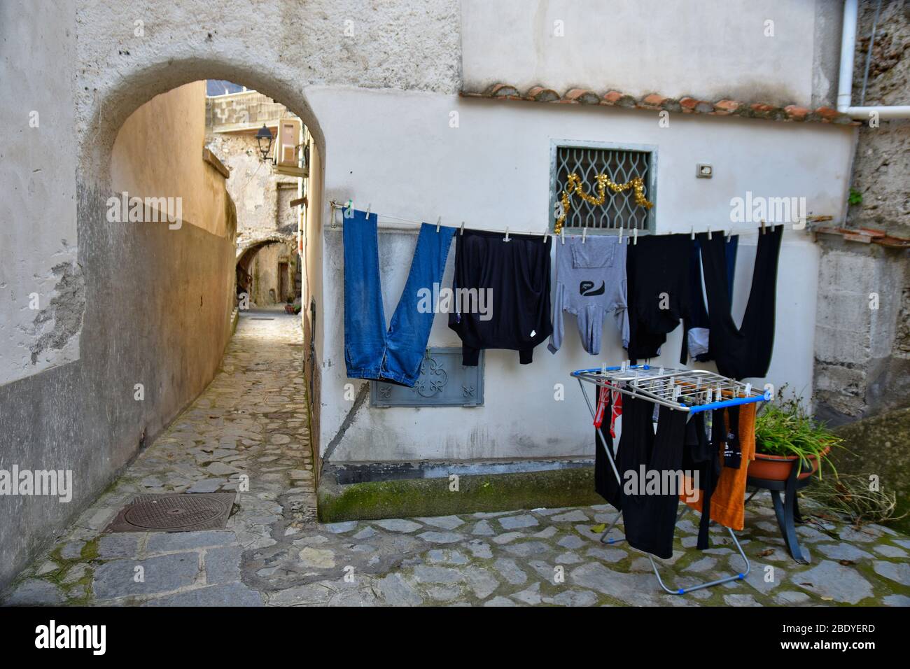 A narrow street between the houses of Scala, a town in the province of ...