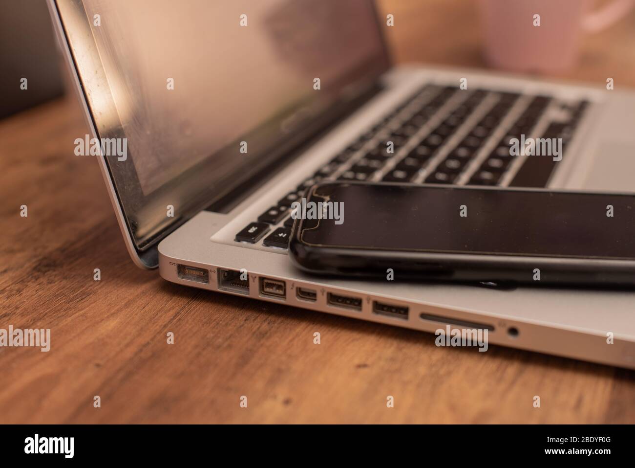 Technology objects against wooden background Stock Photo - Alamy