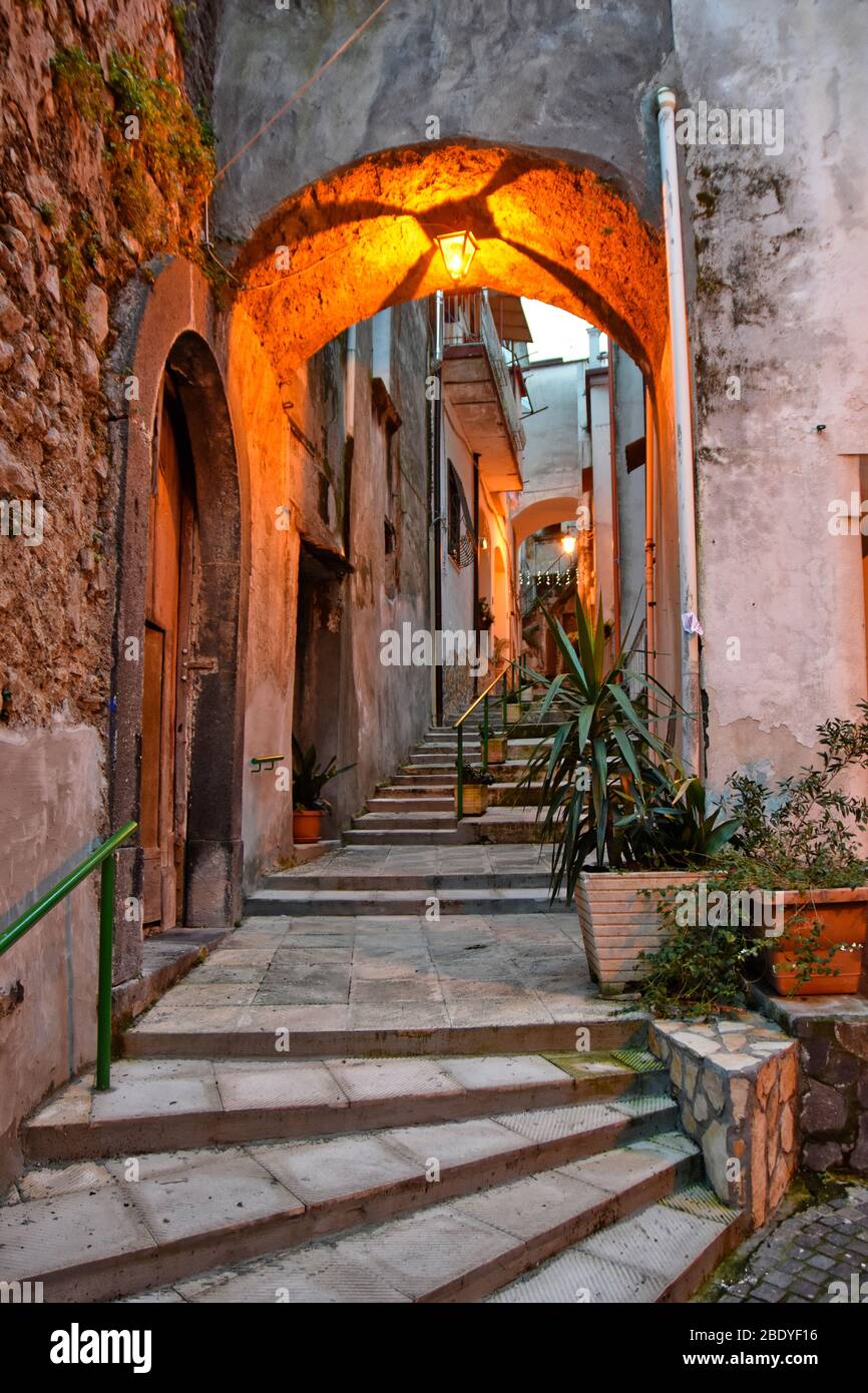 A narrow street between the houses of Corbara, a town in the province ...