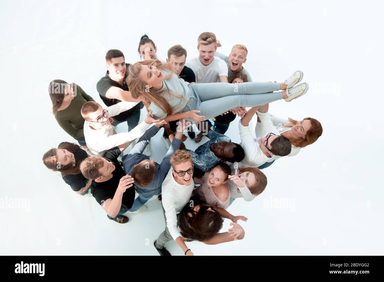 happy team of young people rocking their leader Stock Photo - Alamy