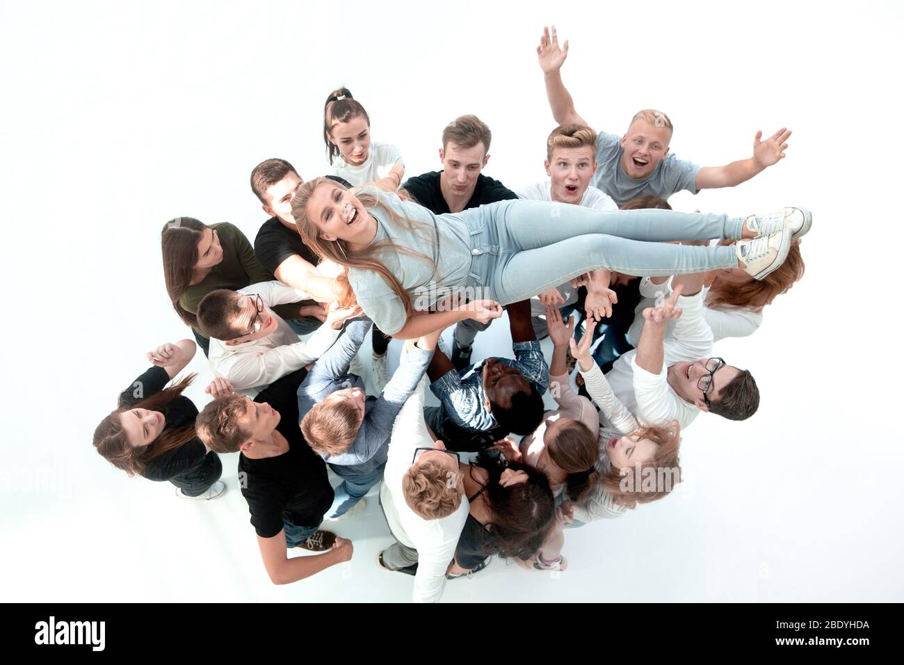 happy team of young people rocking their leader Stock Photo - Alamy