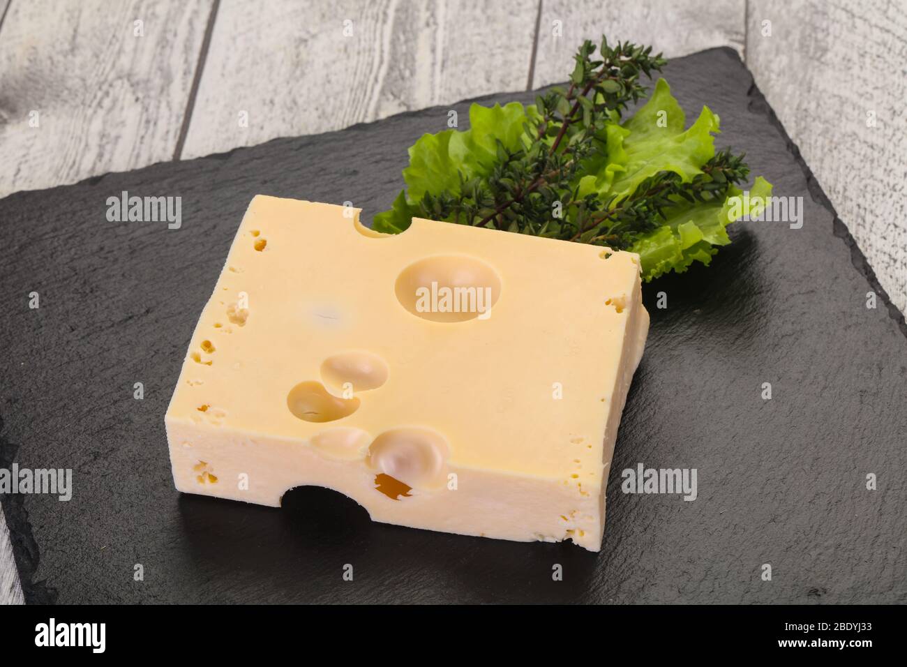 Maasdam cheese brick with thyme branch Stock Photo - Alamy