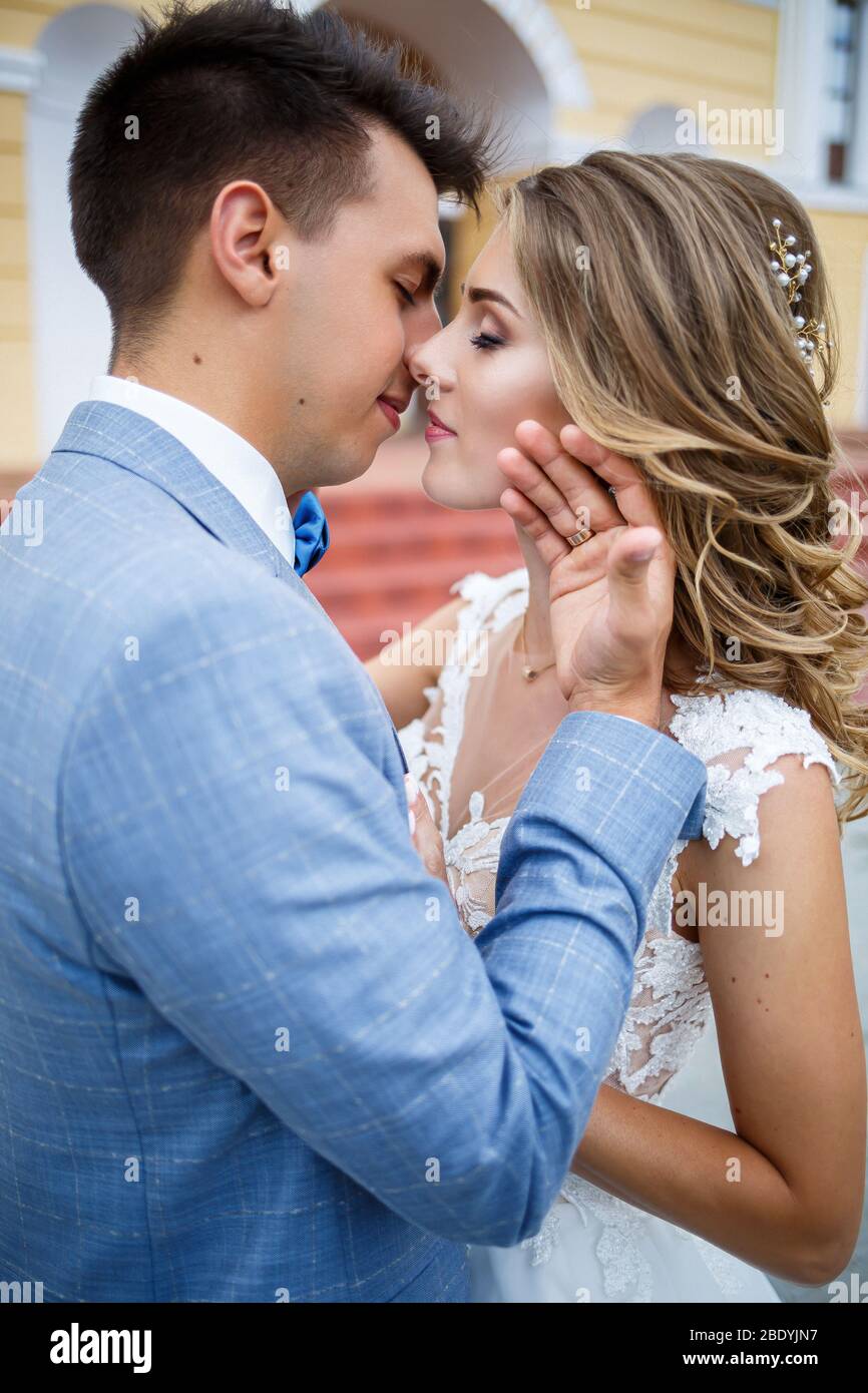 Young stylish guy in the costume of the groom and the bride beautiful ...