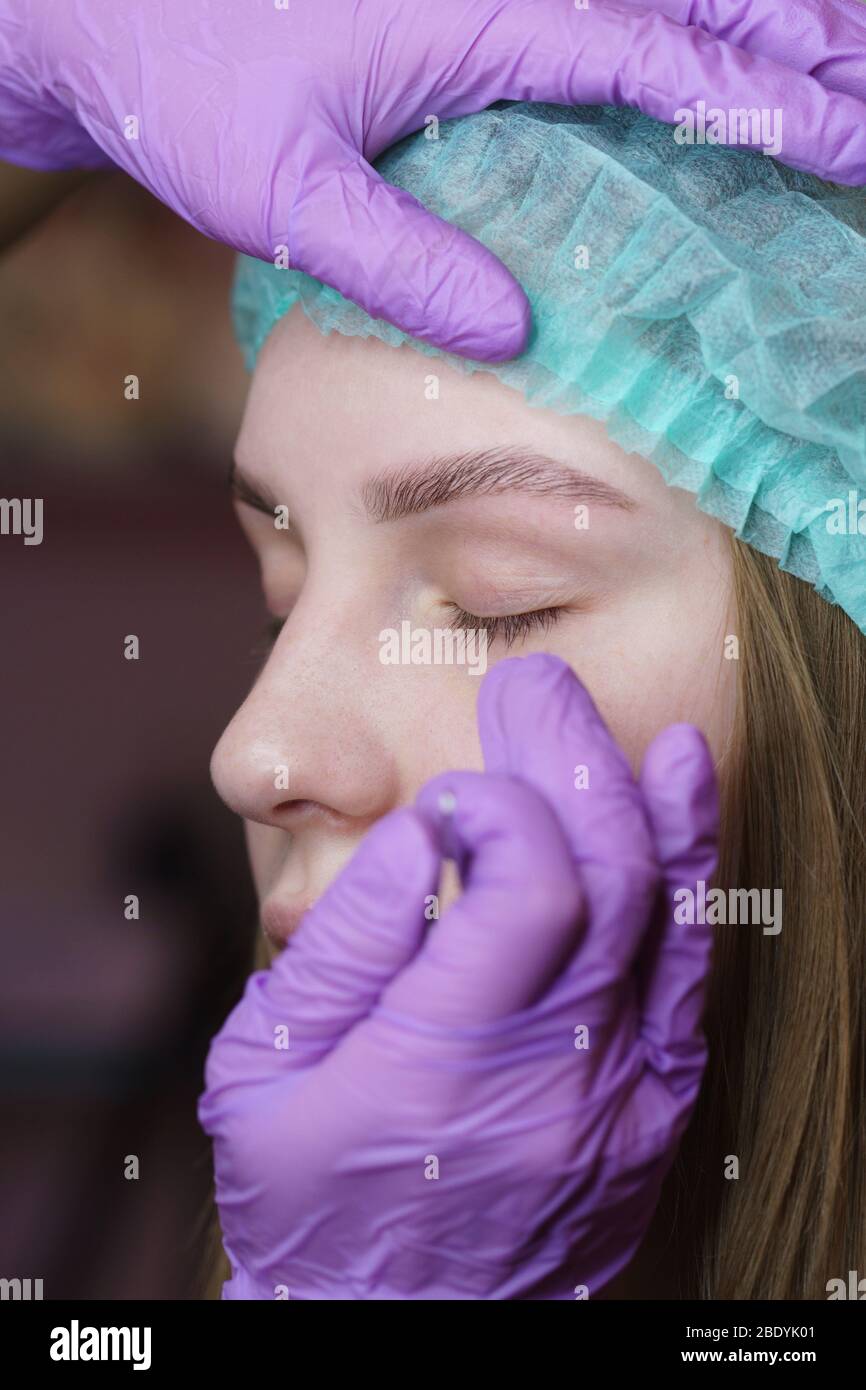 Eyebrow correction with tweezers. Final stage of creating perfect shape ...