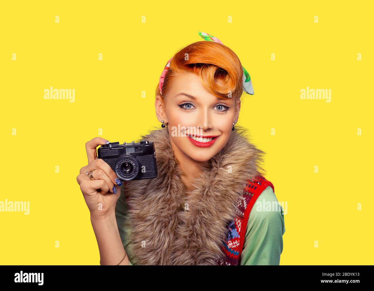 Beautiful smiling young pinup style woman girl showing dslr digital ...