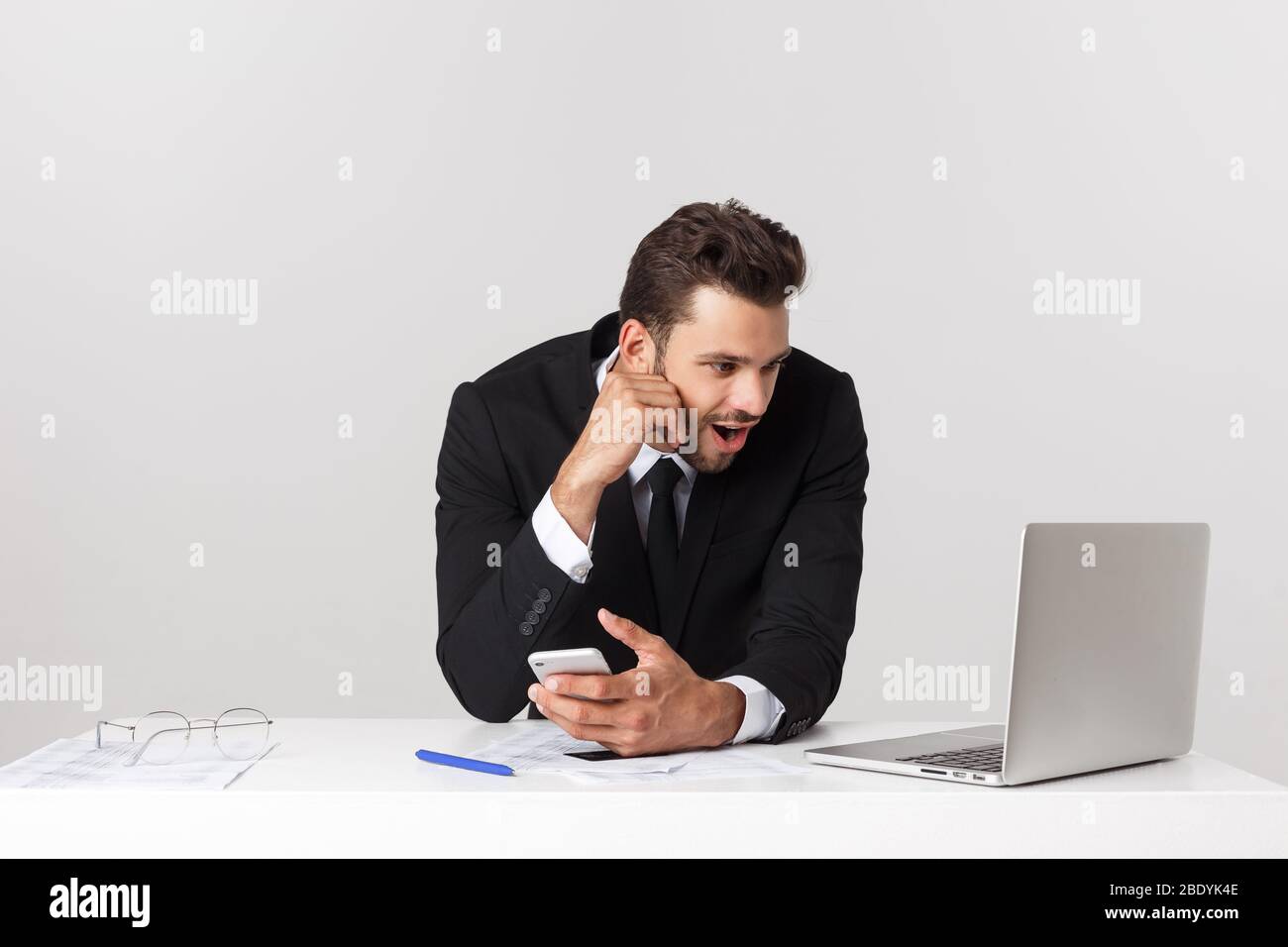 young man shocked with something he see on his laptop computer Stock ...