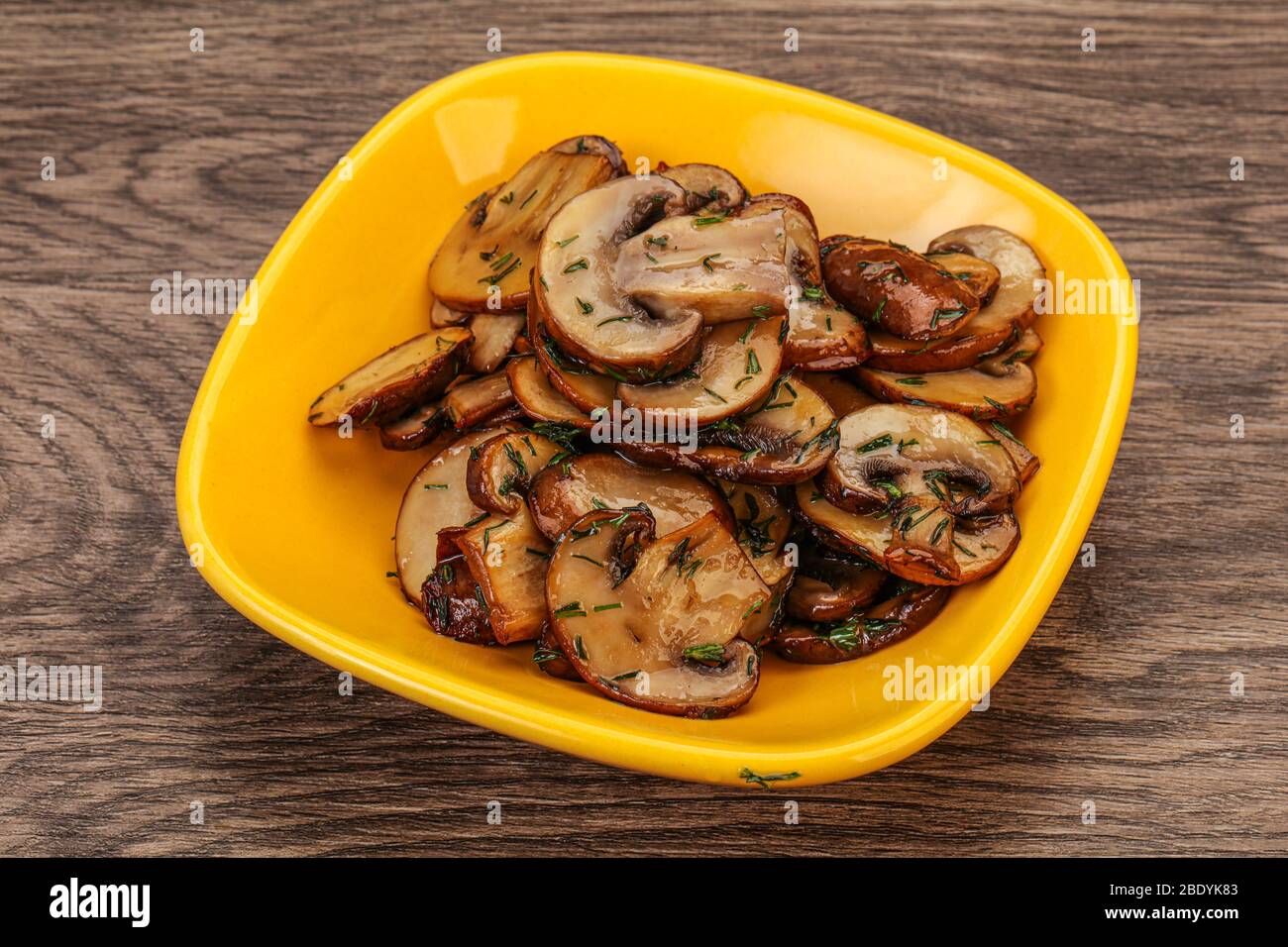 Roasted champignon with herbs and spices in the bowl Stock Photo - Alamy