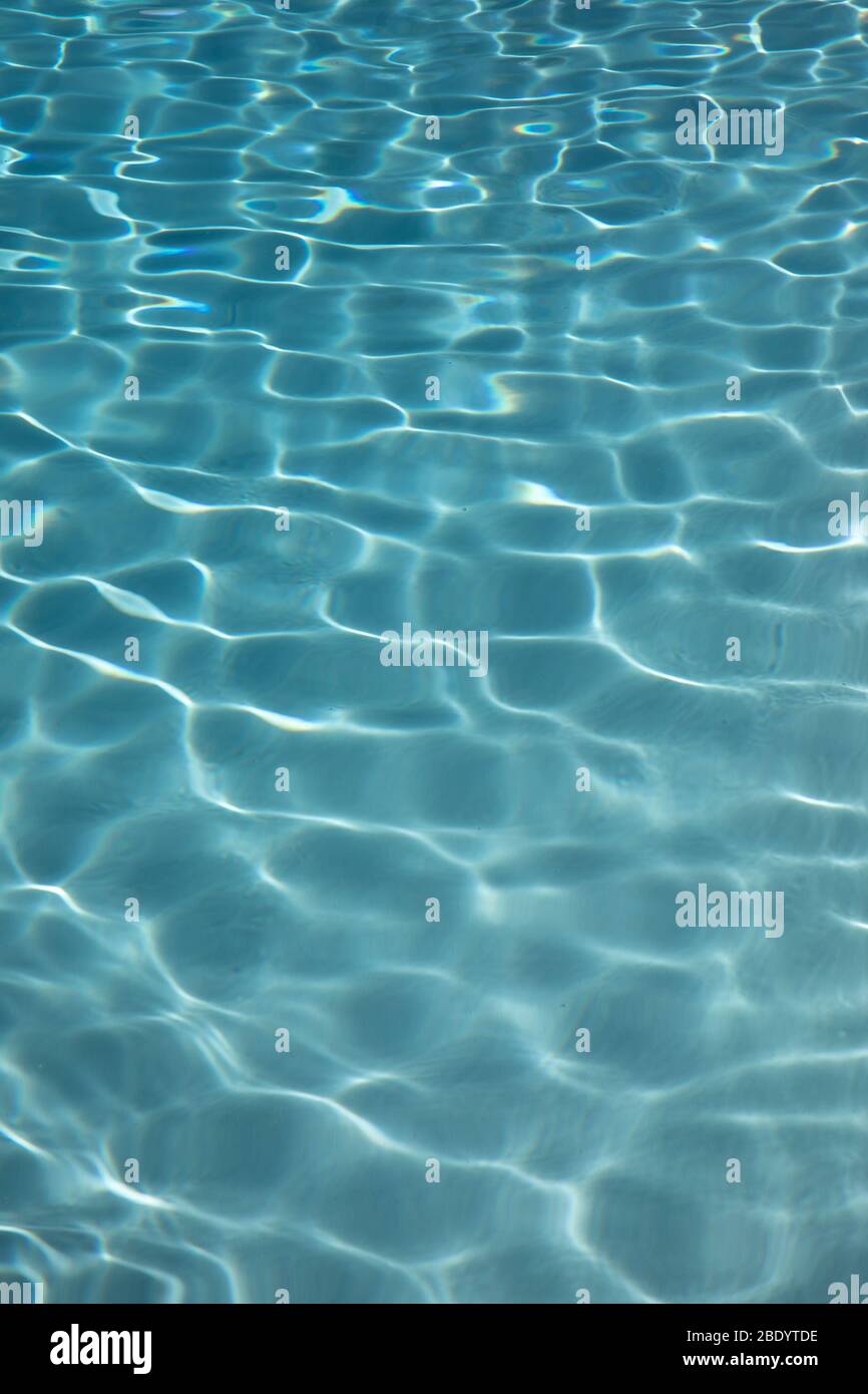 teal pool water is marbled with sun light Stock Photo - Alamy