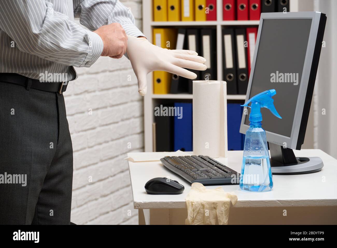 concept of cleaning or disinfecting the office - a businessman cleans ...