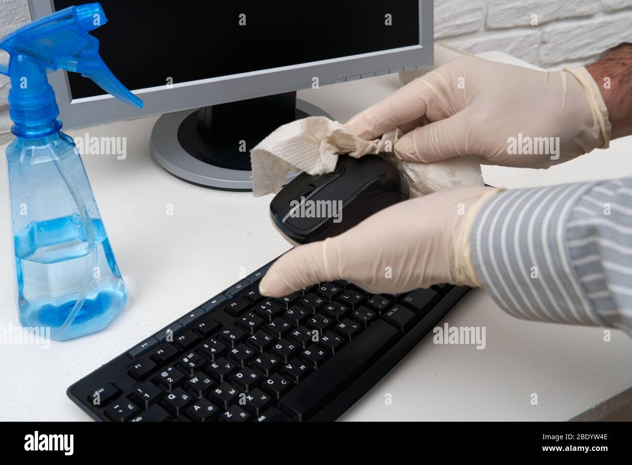 concept of cleaning or disinfecting the office - a businessman cleans ...