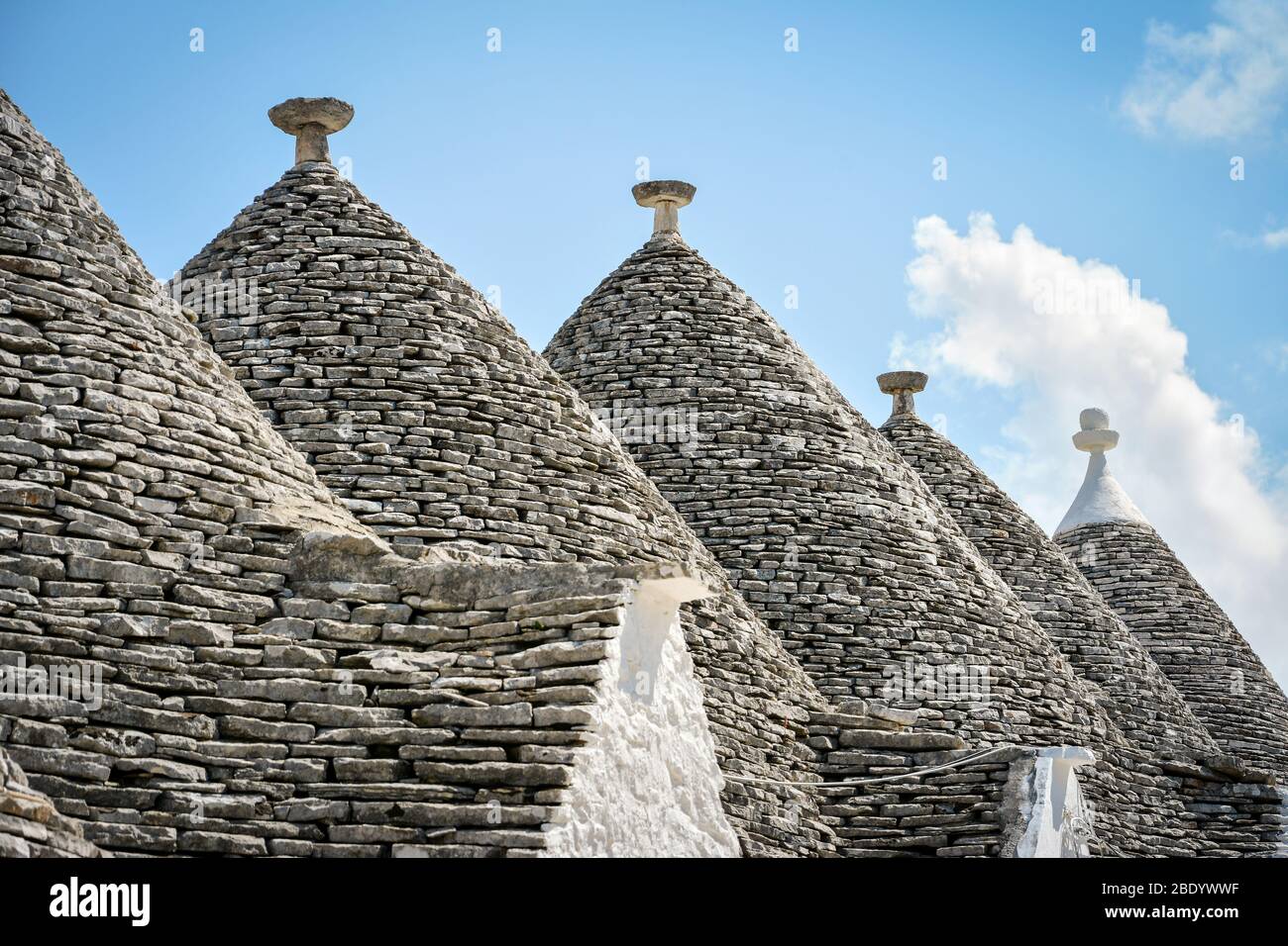 view of the typical conic roof of trullo buildings. Alberobello, Puglia ...