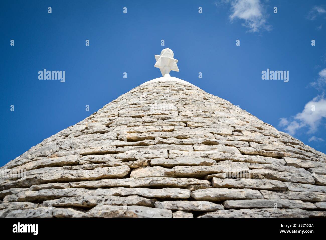 view of the typical conic roof of trullo buildings. Alberobello, Puglia ...