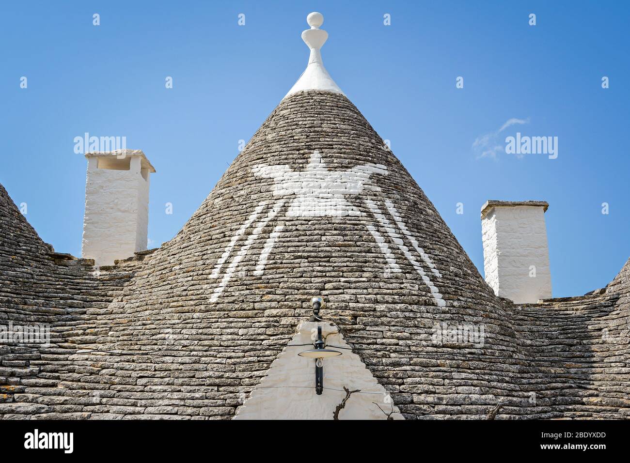 view of the typical conic roof of trullo buildings. Alberobello, Puglia ...