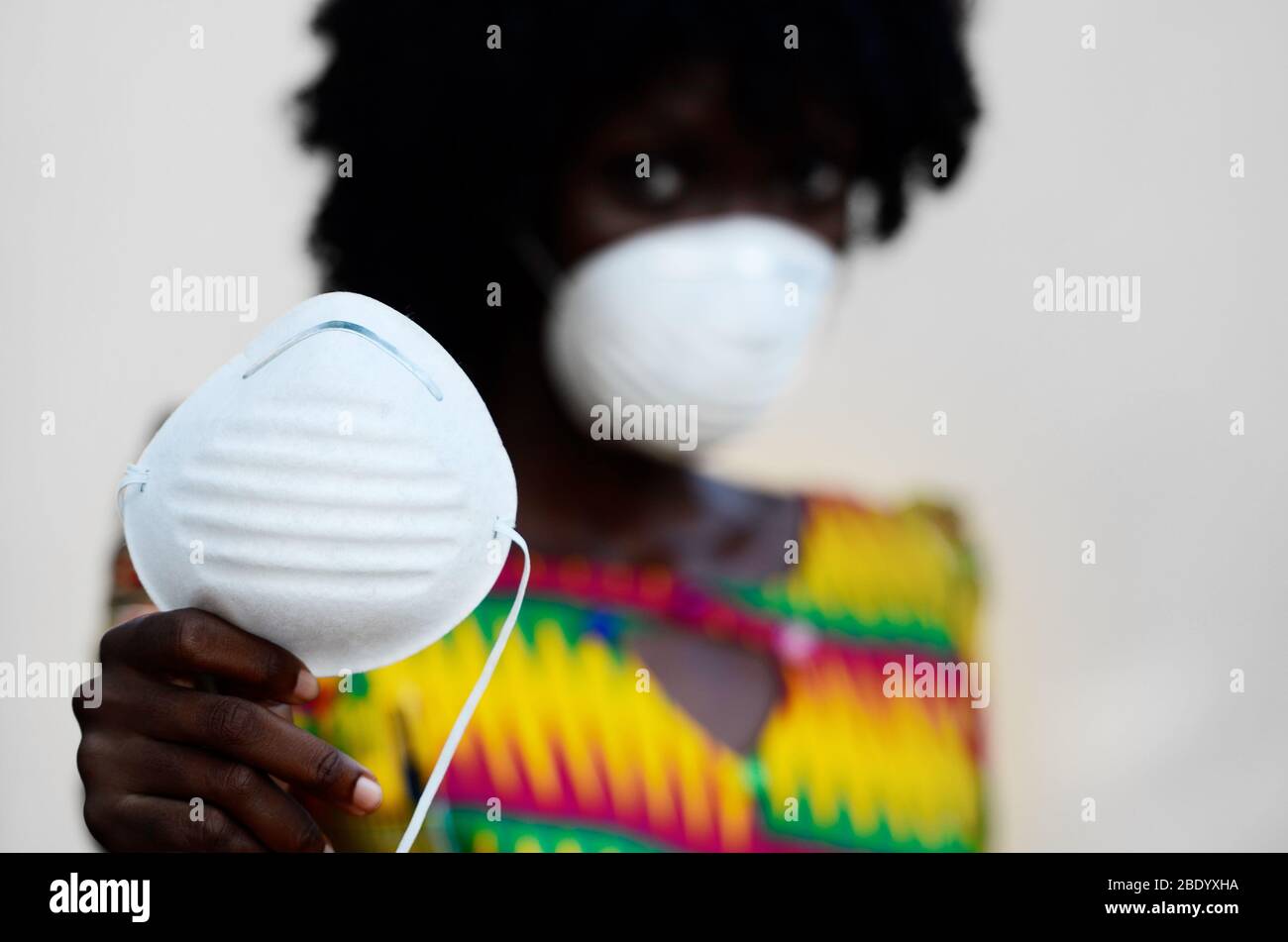 Close Up Of African Nurse Wearing Face Mask and giving Facemasks to ...