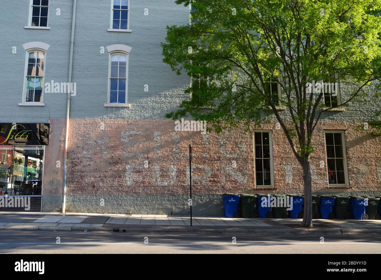 A wall with faded advertisement in the historic district of downtown ...
