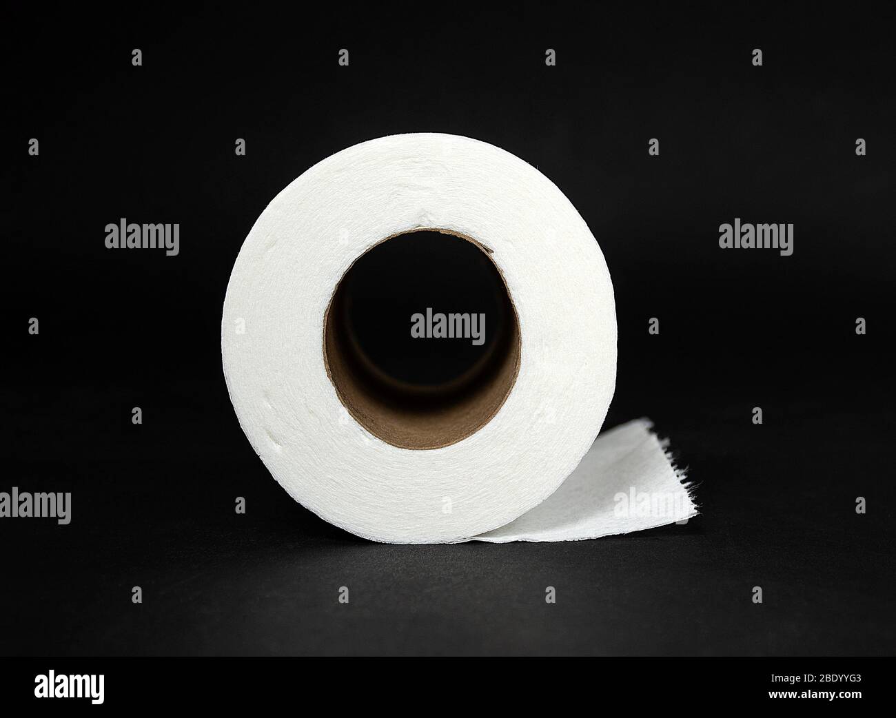 side view of roll of white toilet paper isolated on black Stock Photo ...