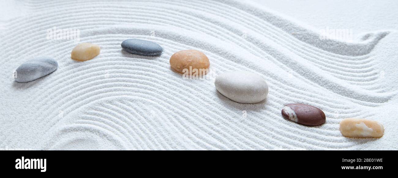 Zen pebbles on white sand pattern Stock Photo - Alamy