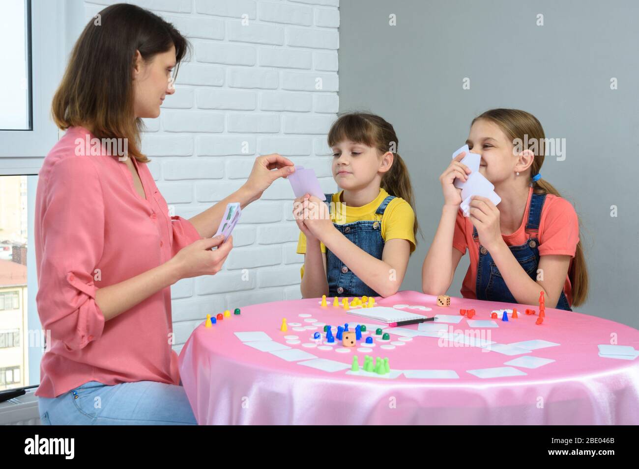 In the process of a board game, mom chooses a card from her daughter's ...