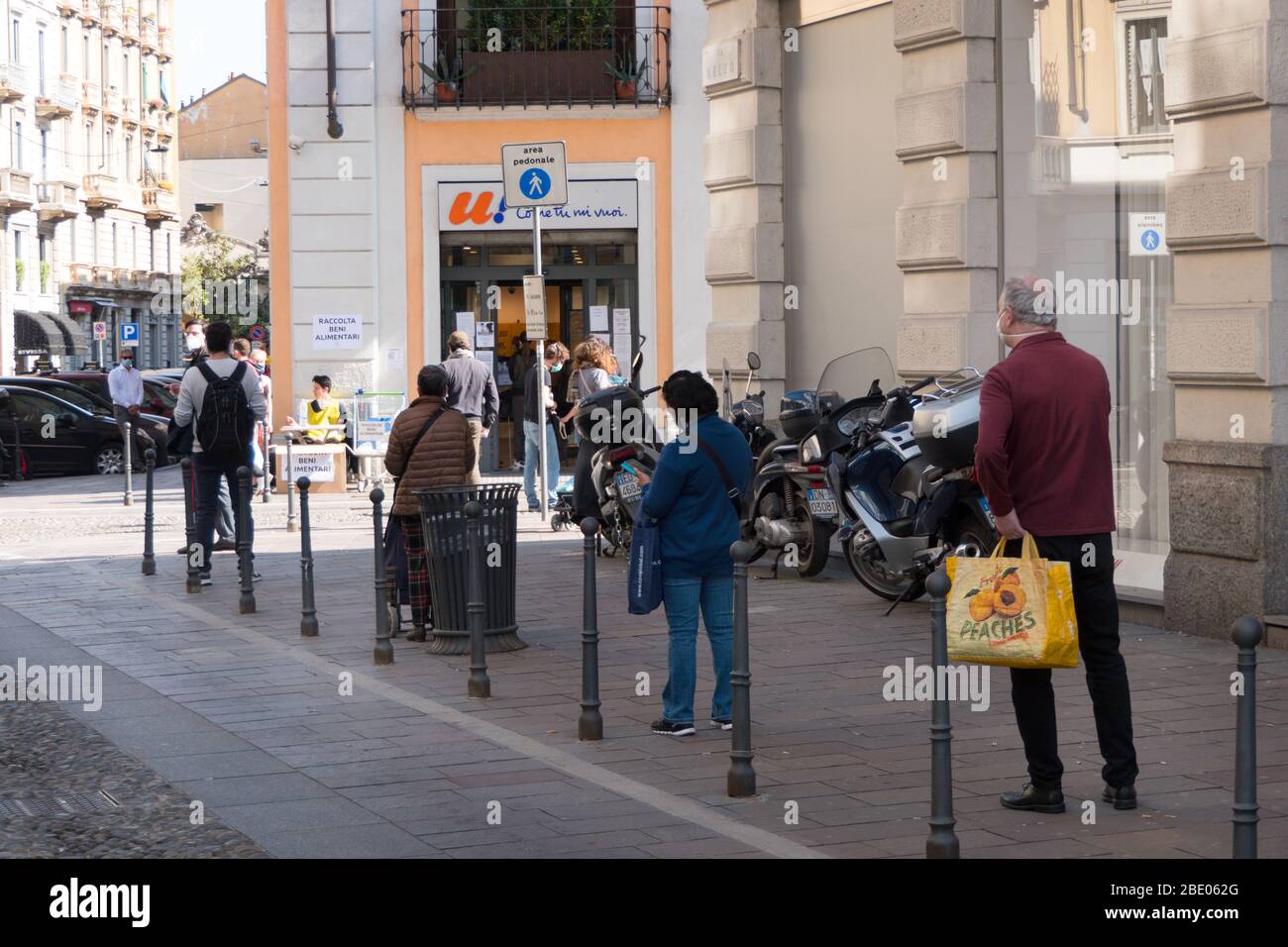 People waiting in line to enter supermarket and shopping for food in ...