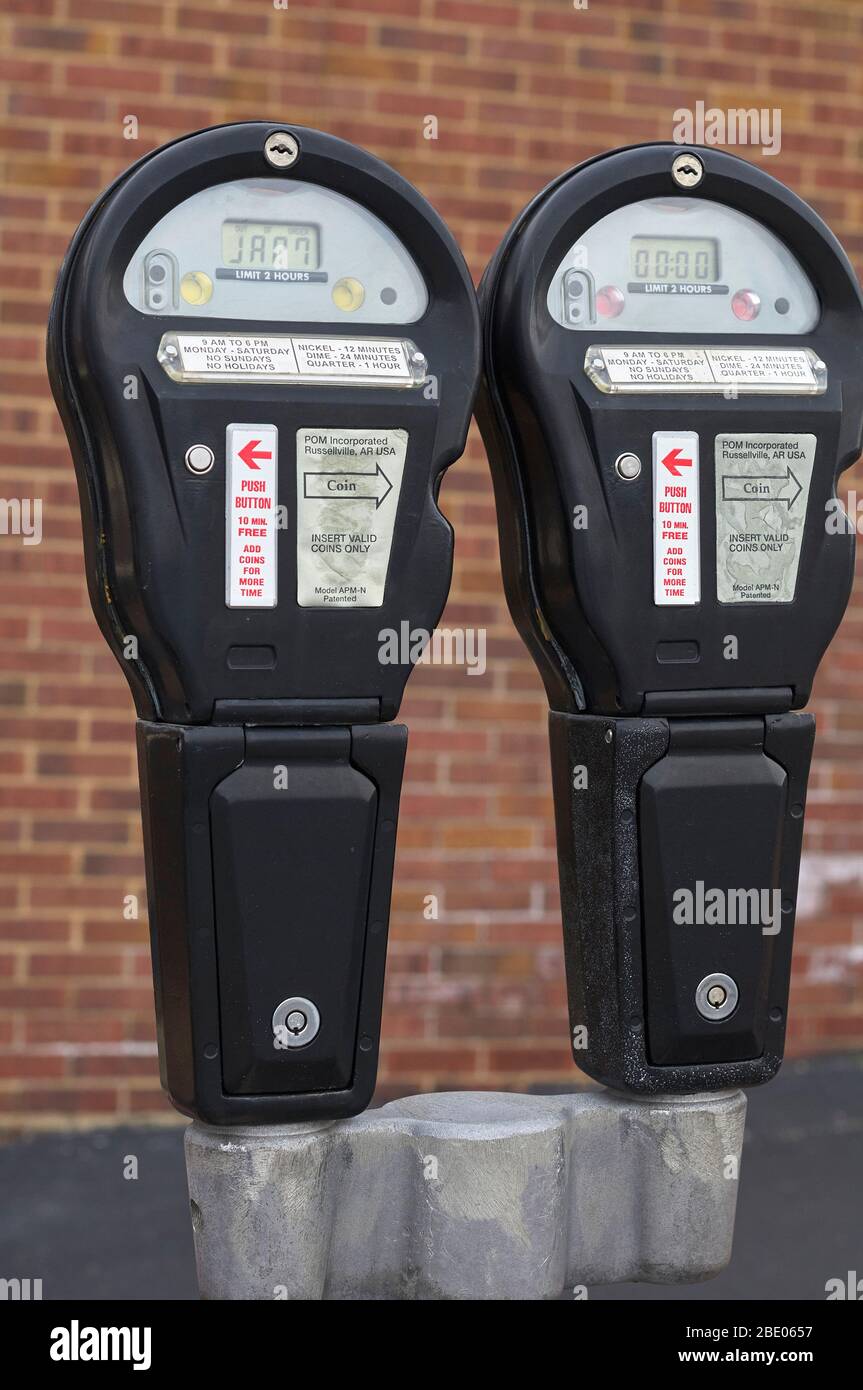 pair of parking meters on curb Stock Photo - Alamy