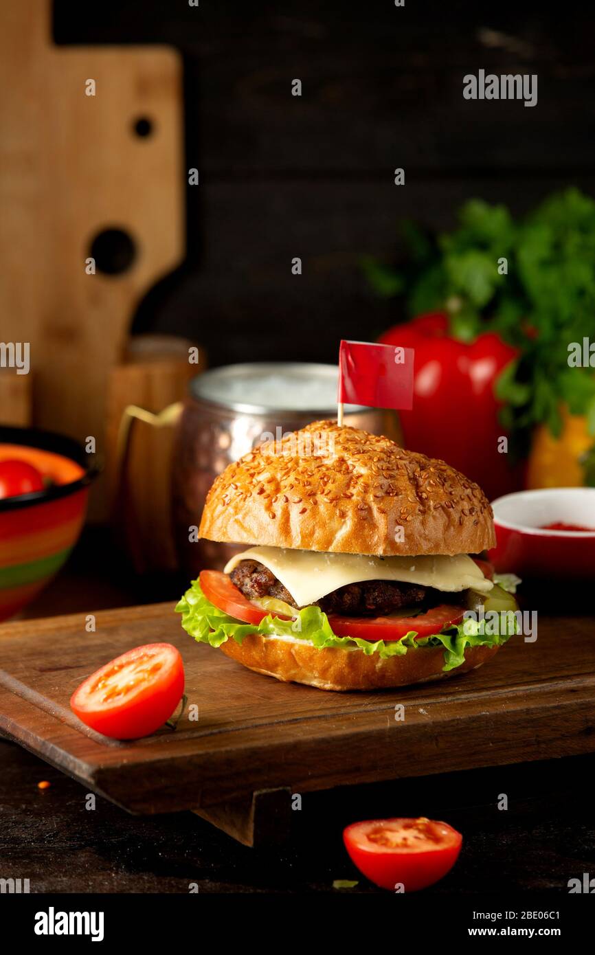 classic cheseeburger on cutting desk Stock Photo - Alamy