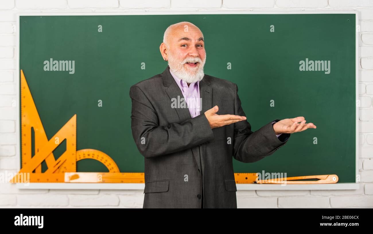 presenting product. get knowledge here. senior man teacher use math ...