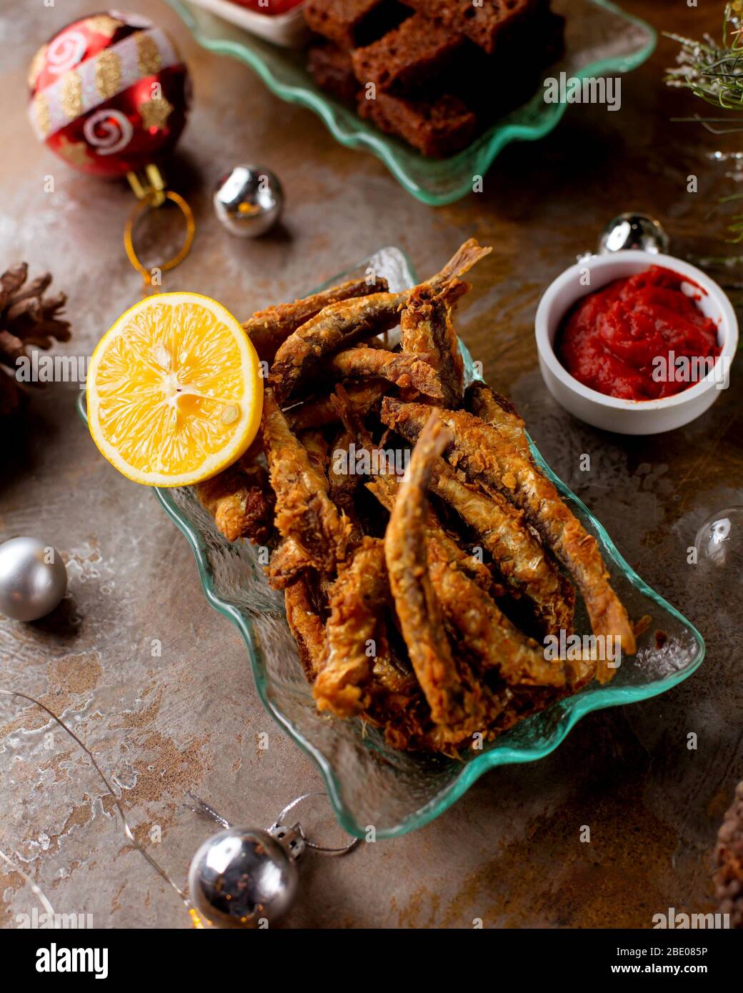 fried fish with lemon slice and ketchup Stock Photo - Alamy
