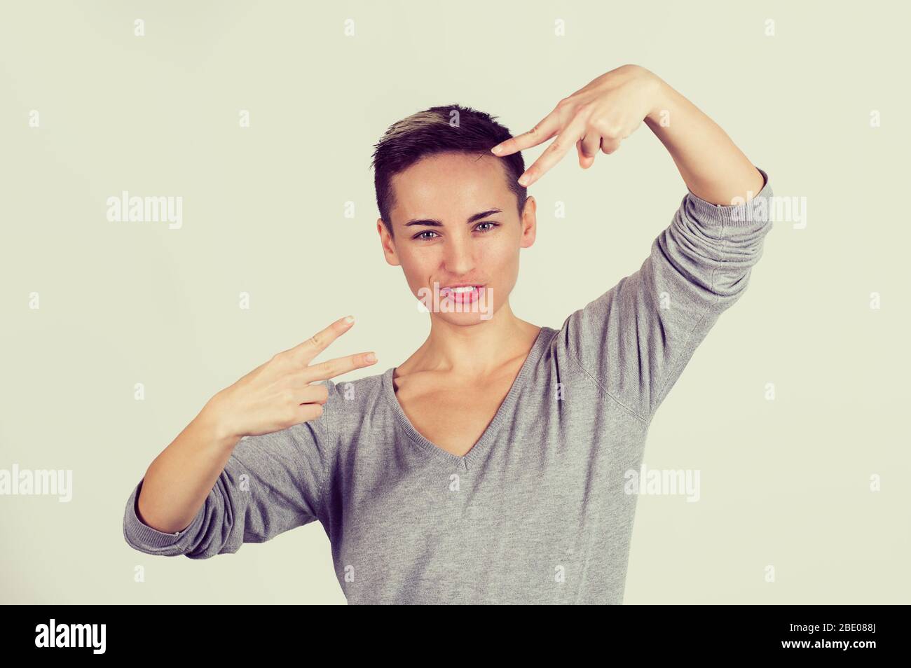 Portrait lovely happy teenage girl showing victory or peace sign ...