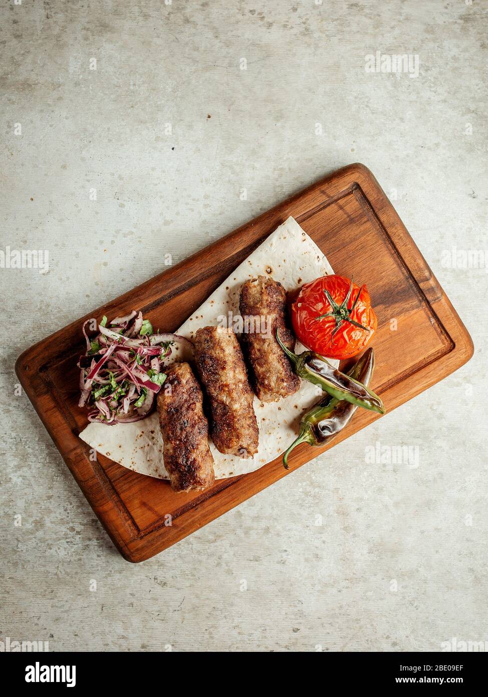 lule kebab with fried tomato and sliced onions Stock Photo - Alamy
