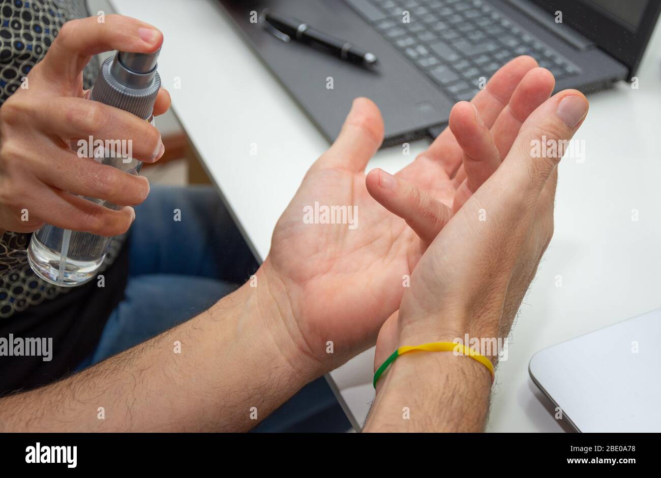 Woman at work puts alcohol in her partner's hands Stock Photo - Alamy