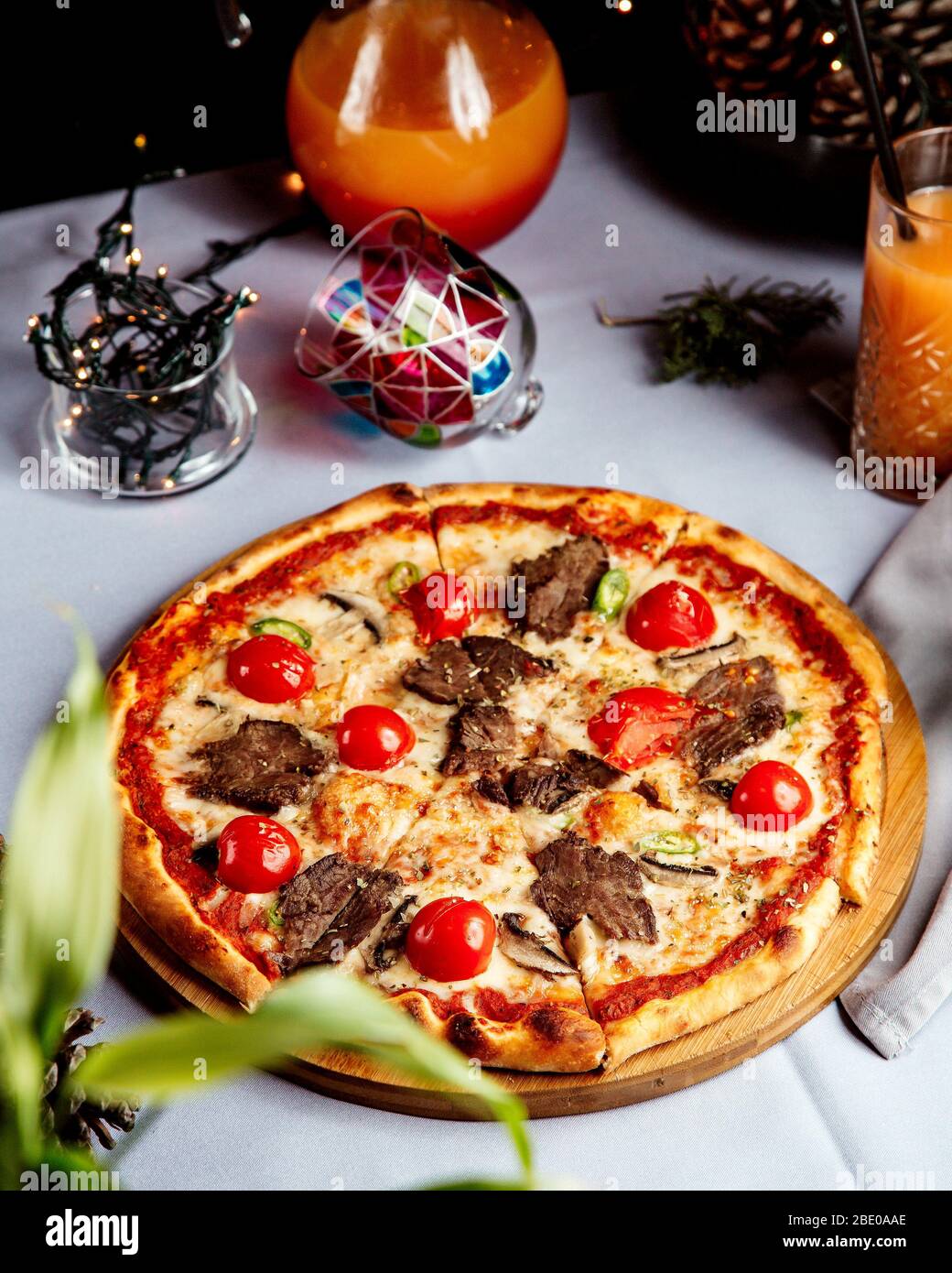 mixed pizza with meat pieces and tomato Stock Photo - Alamy