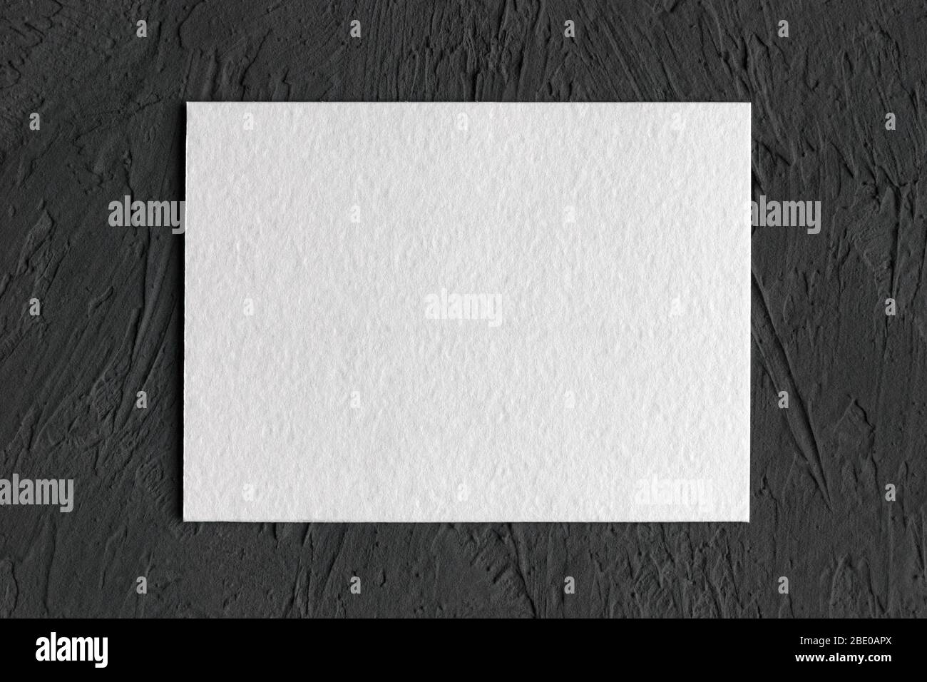 white textured paper card on dark concrete background Stock Photo - Alamy