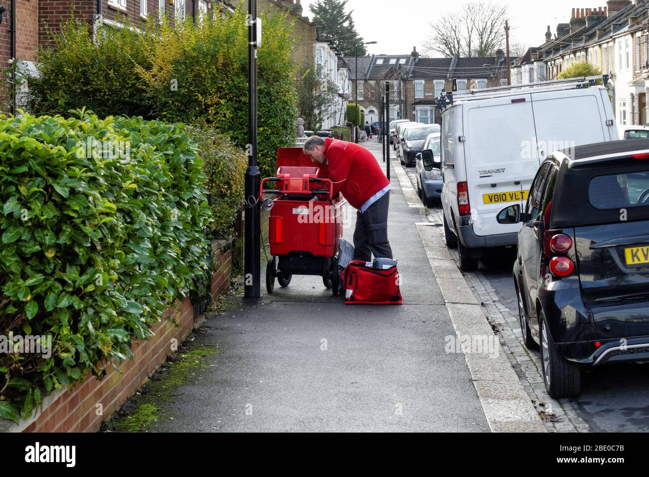 Royal Mail postman on residential street in London England United ...