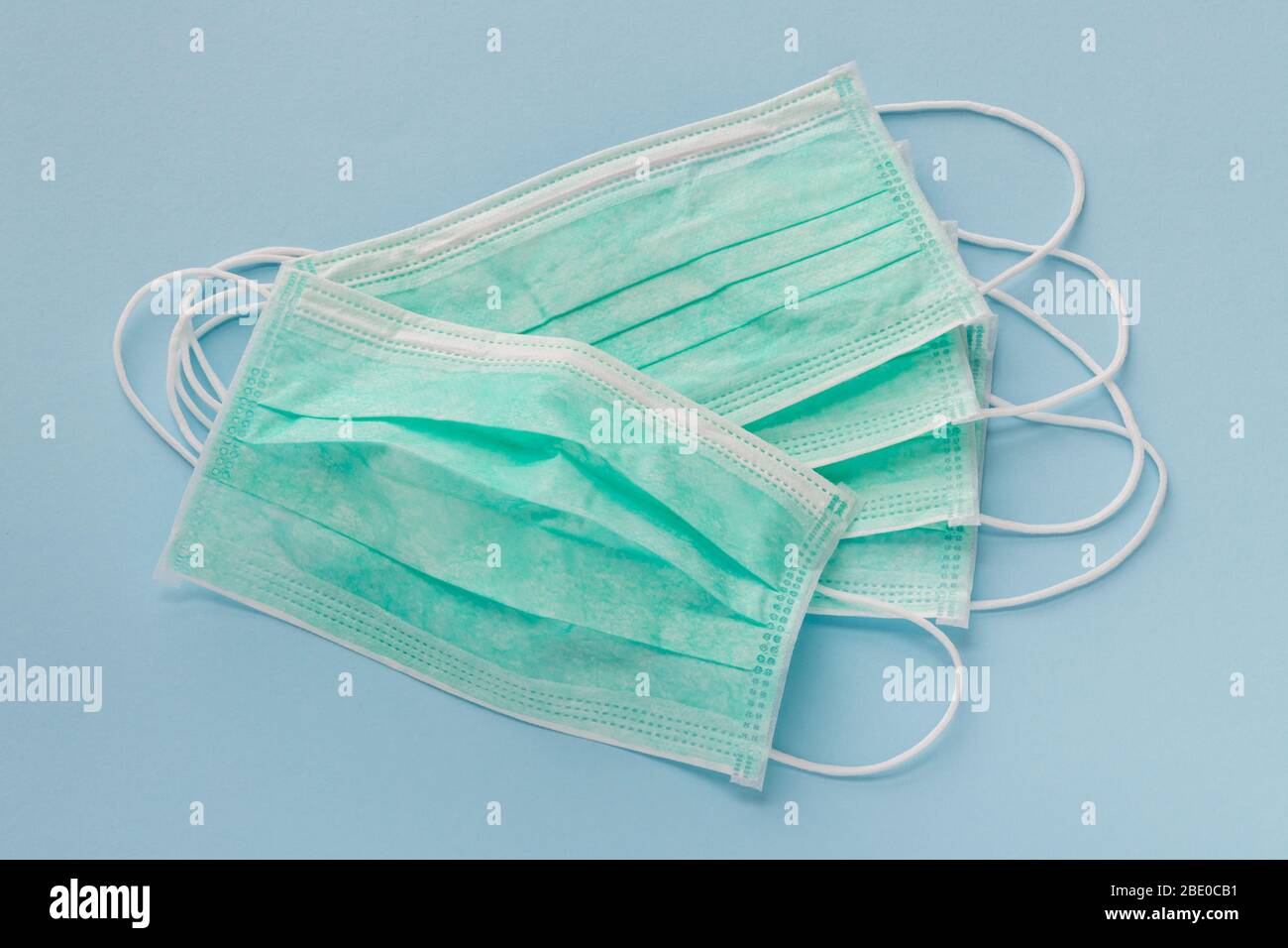 Couple of medical/surgical mask on light blue bacground. Protection ...