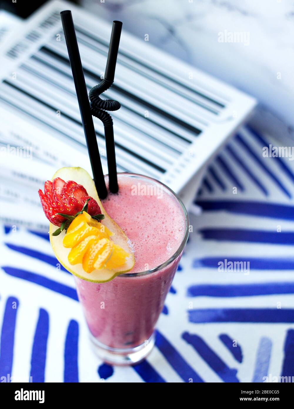 strawberry milkshake with sliced fruits on top Stock Photo - Alamy