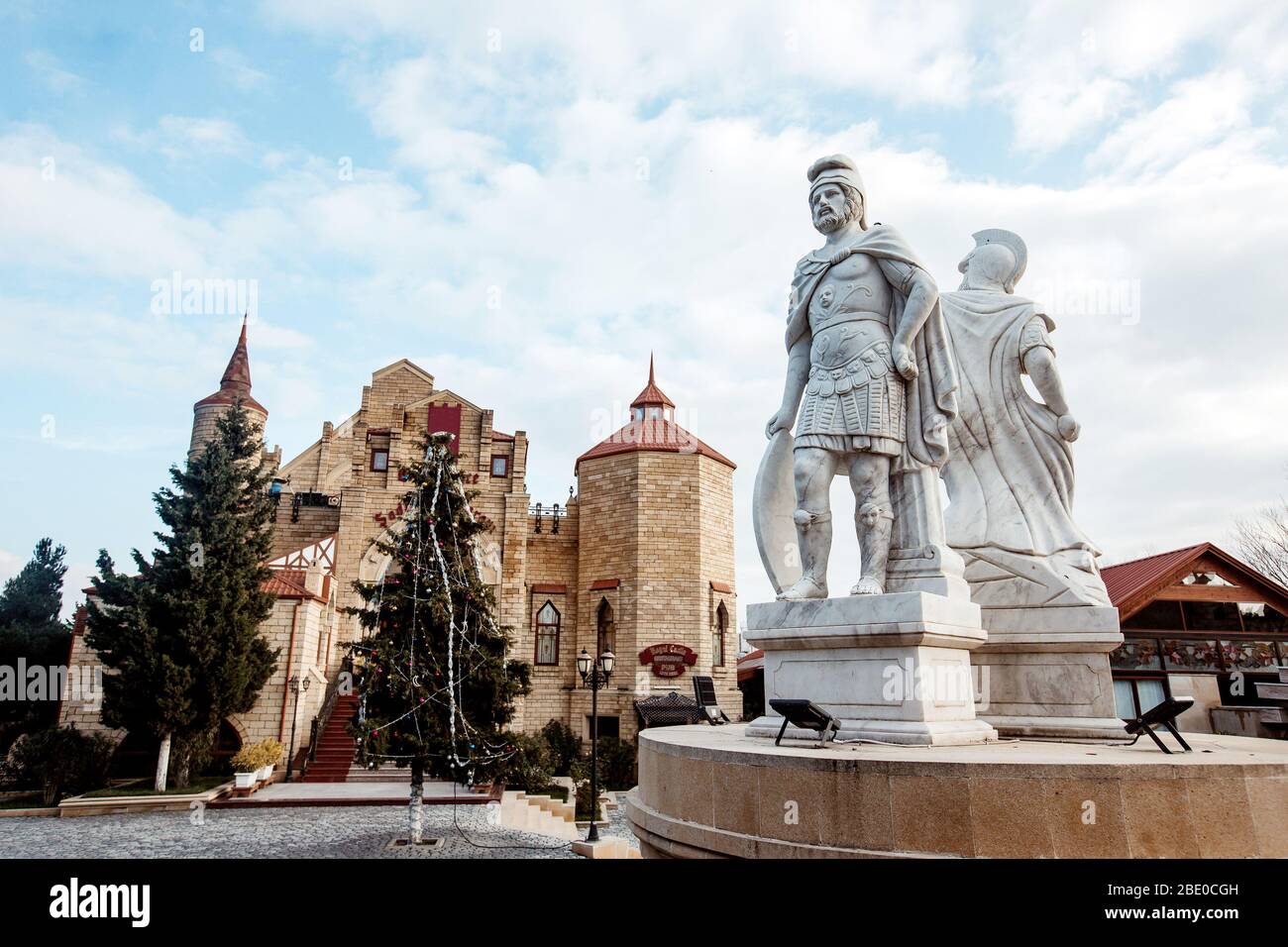 statues in front of castle Stock Photo - Alamy