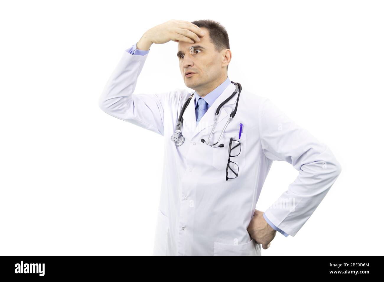 Handsome doctor looking shocked and frustrated with hand on forehead ...