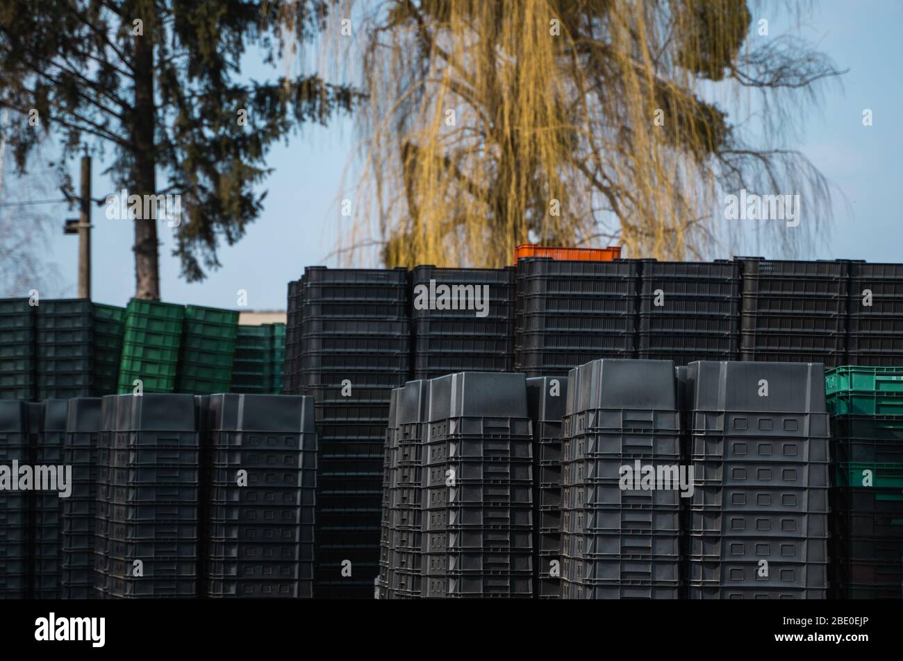 Black plastic boxes in a warehouse outdoor Stock Photo - Alamy