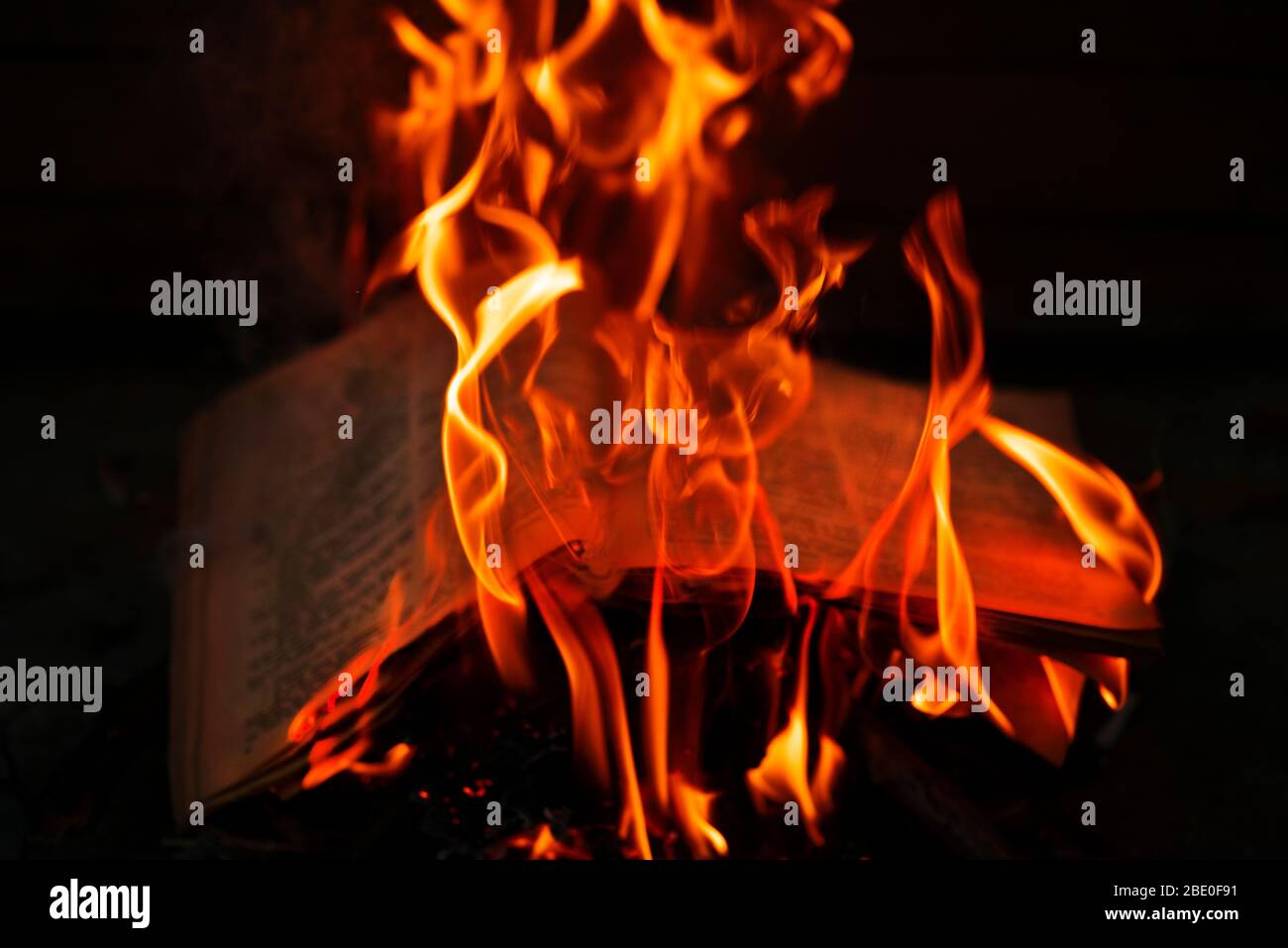 Concept for the destruction of confidential documents.Burning book on ...