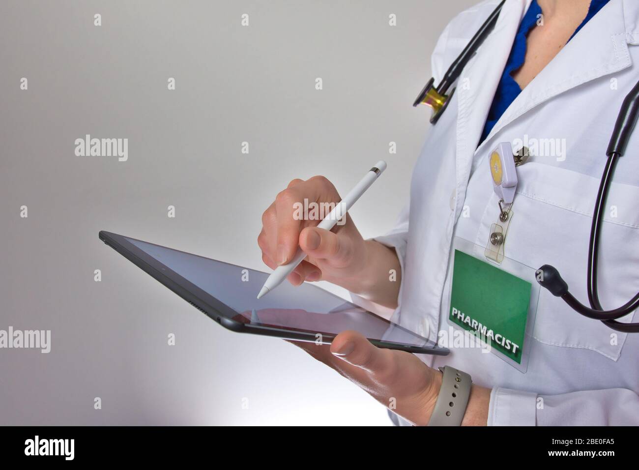 Woman using tablet in healthcare. Lady pharmacist filling out ...