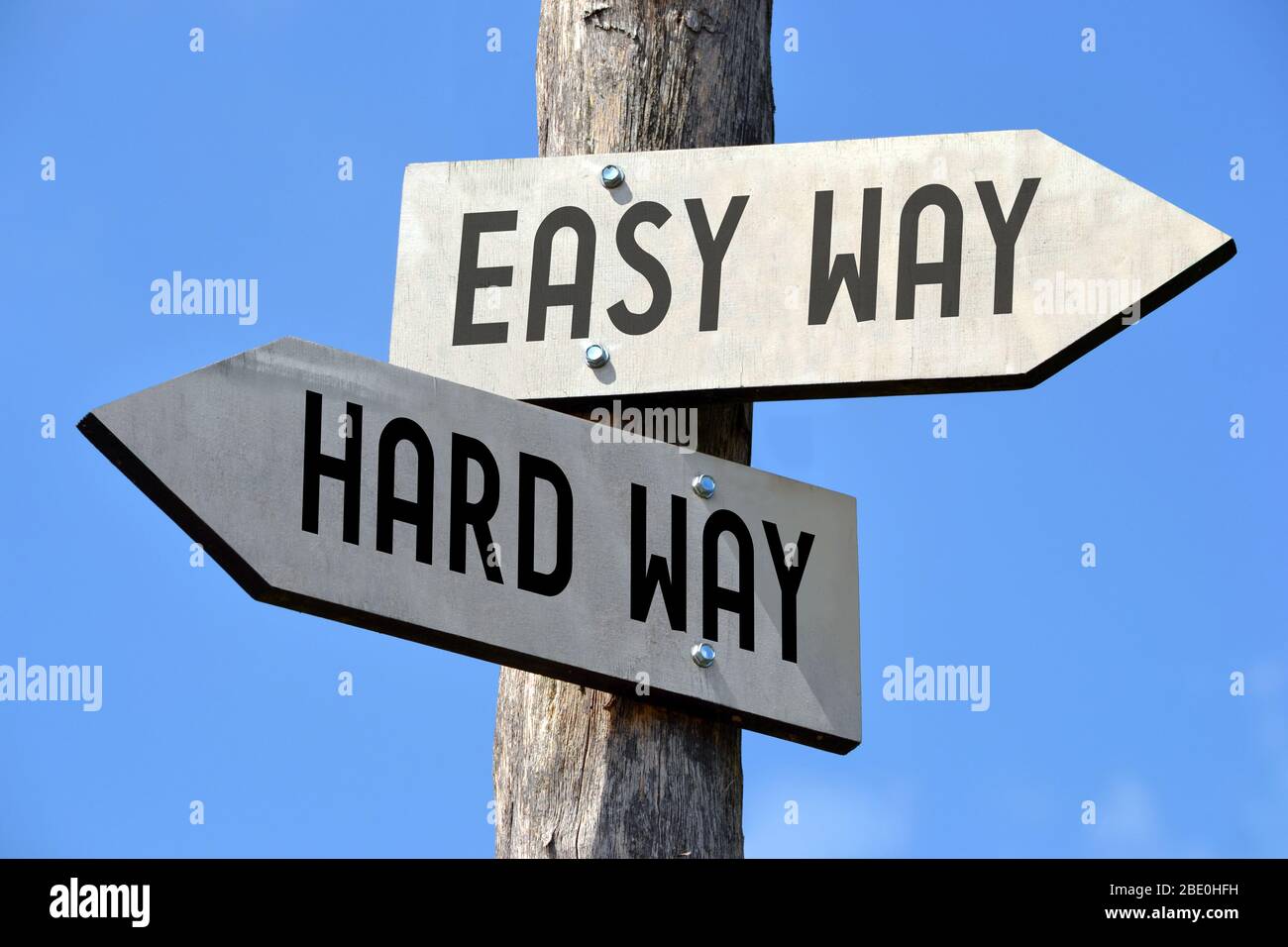 Easy and hard way signpost Stock Photo - Alamy