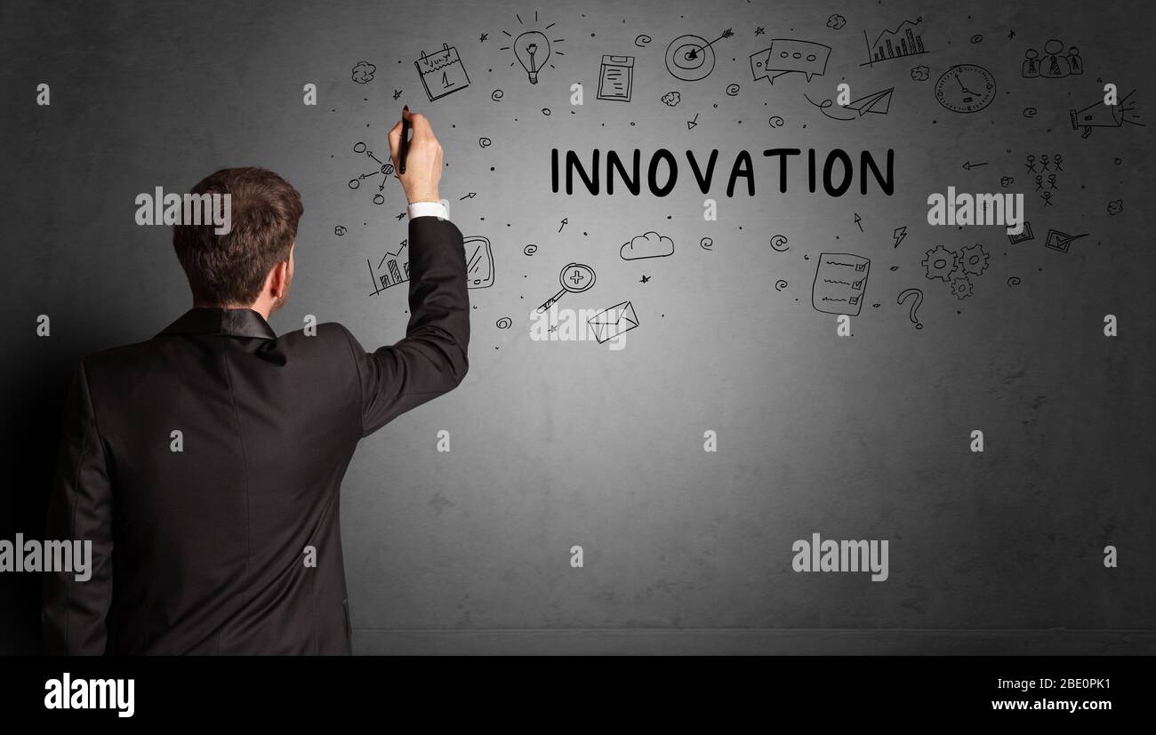 businessman drawing a creative idea sketch with INNOVATION inscription ...