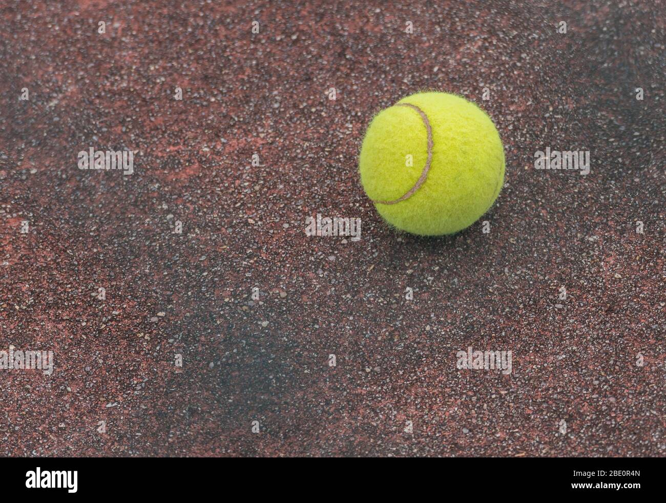 one yellow tennis ball on asphalt ground outdoors Stock Photo - Alamy