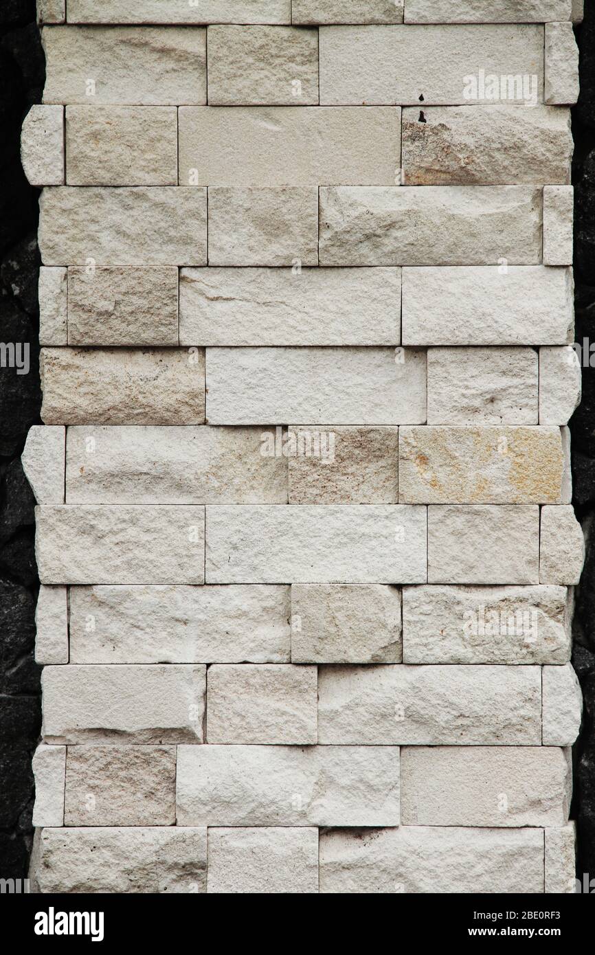 a beige color stacked stone wall texture background Stock Photo - Alamy
