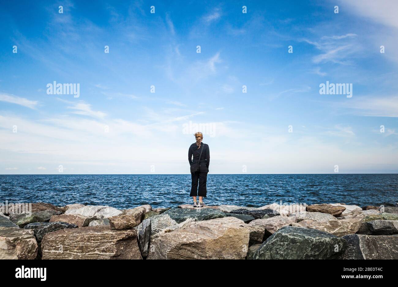 Lone figure looking out to sea hi-res stock photography and images - Alamy